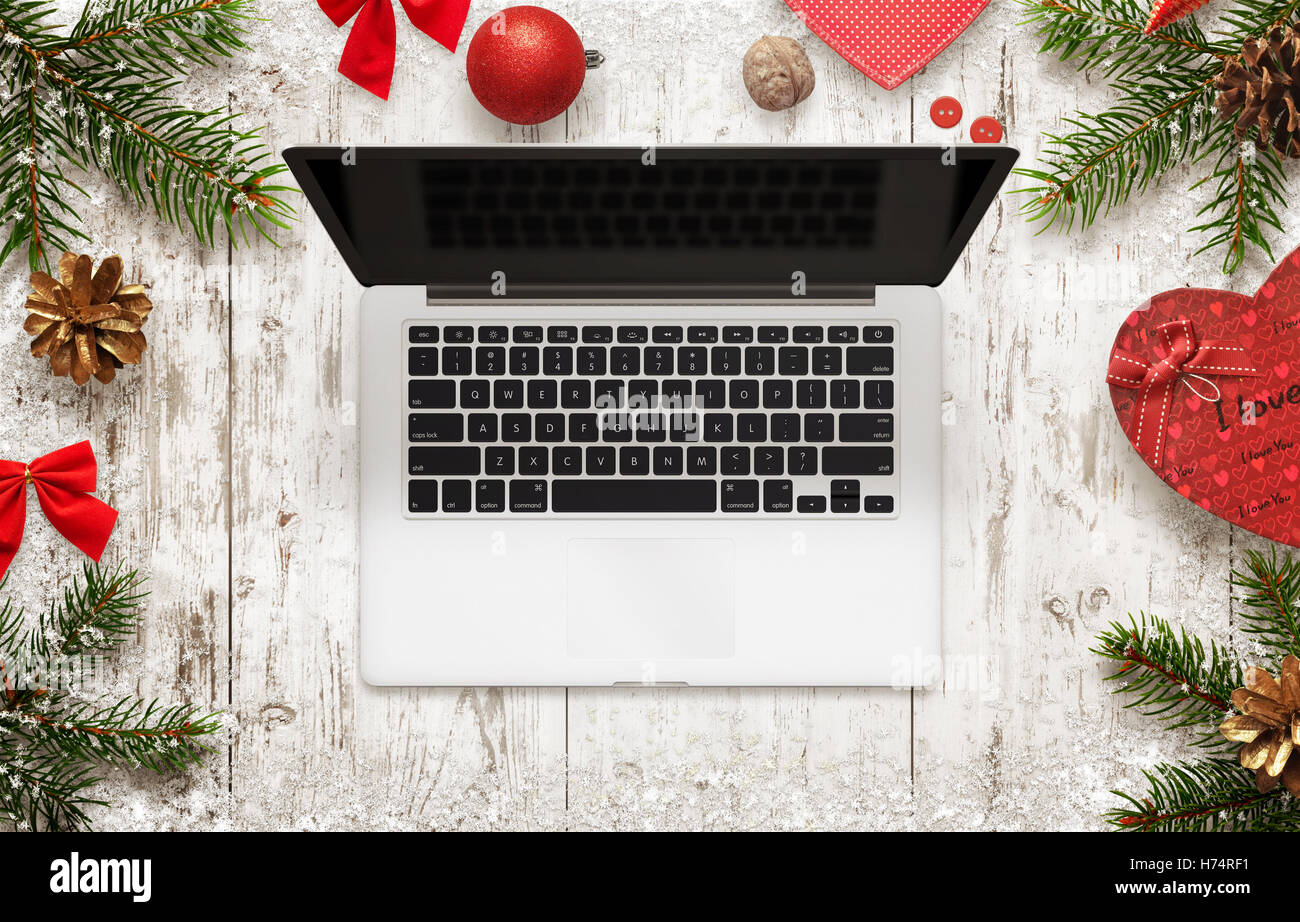 Laptop computer on christmas scene. Top view of table with christmas ...