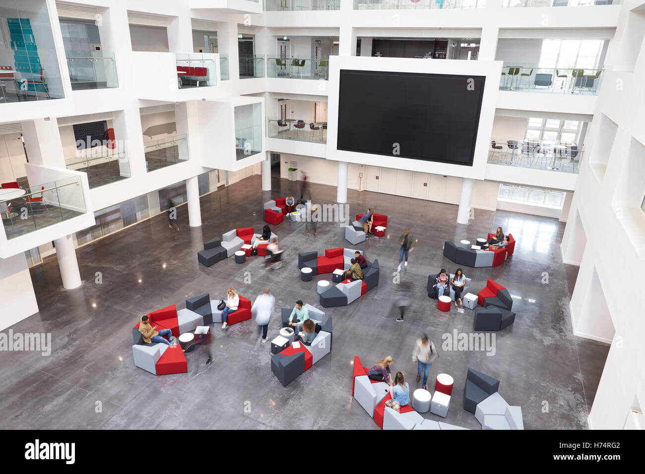 Modern university lobby atrium and glass fronted study rooms Stock ...
