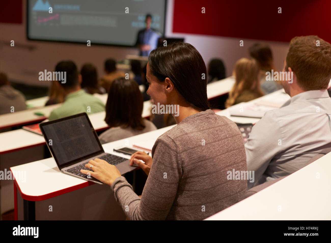 Adult student using laptop computer at a university lecture Stock Photo ...