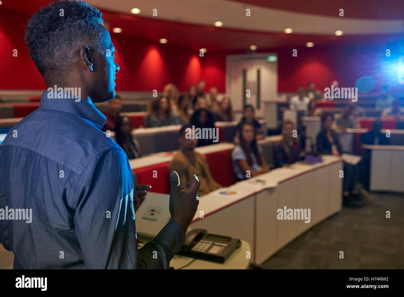 Man lecturing students in a university lecture theatre Stock Photo - Alamy