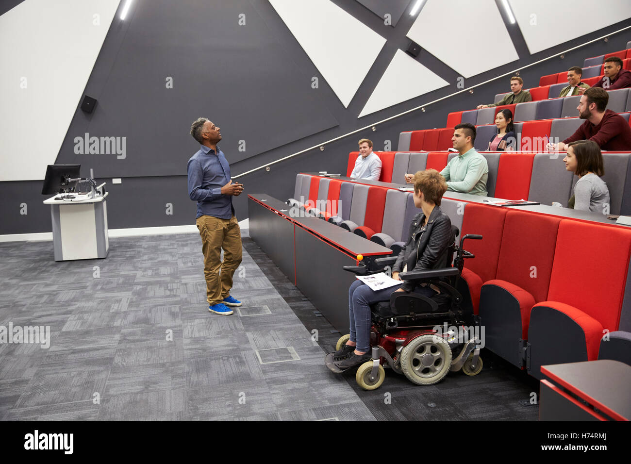 Man lecturing students in a university lecture theatre Stock Photo - Alamy