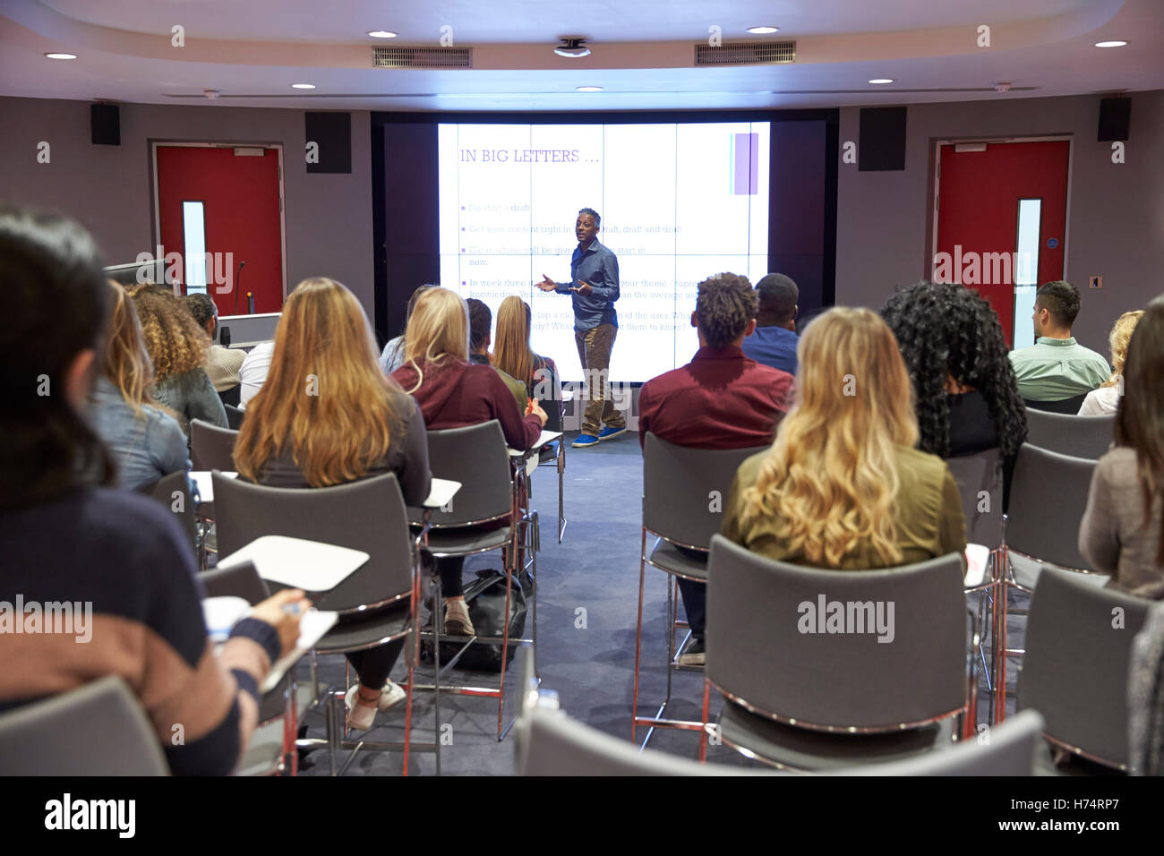 Student lecture in modern university classroom, back view Stock Photo ...