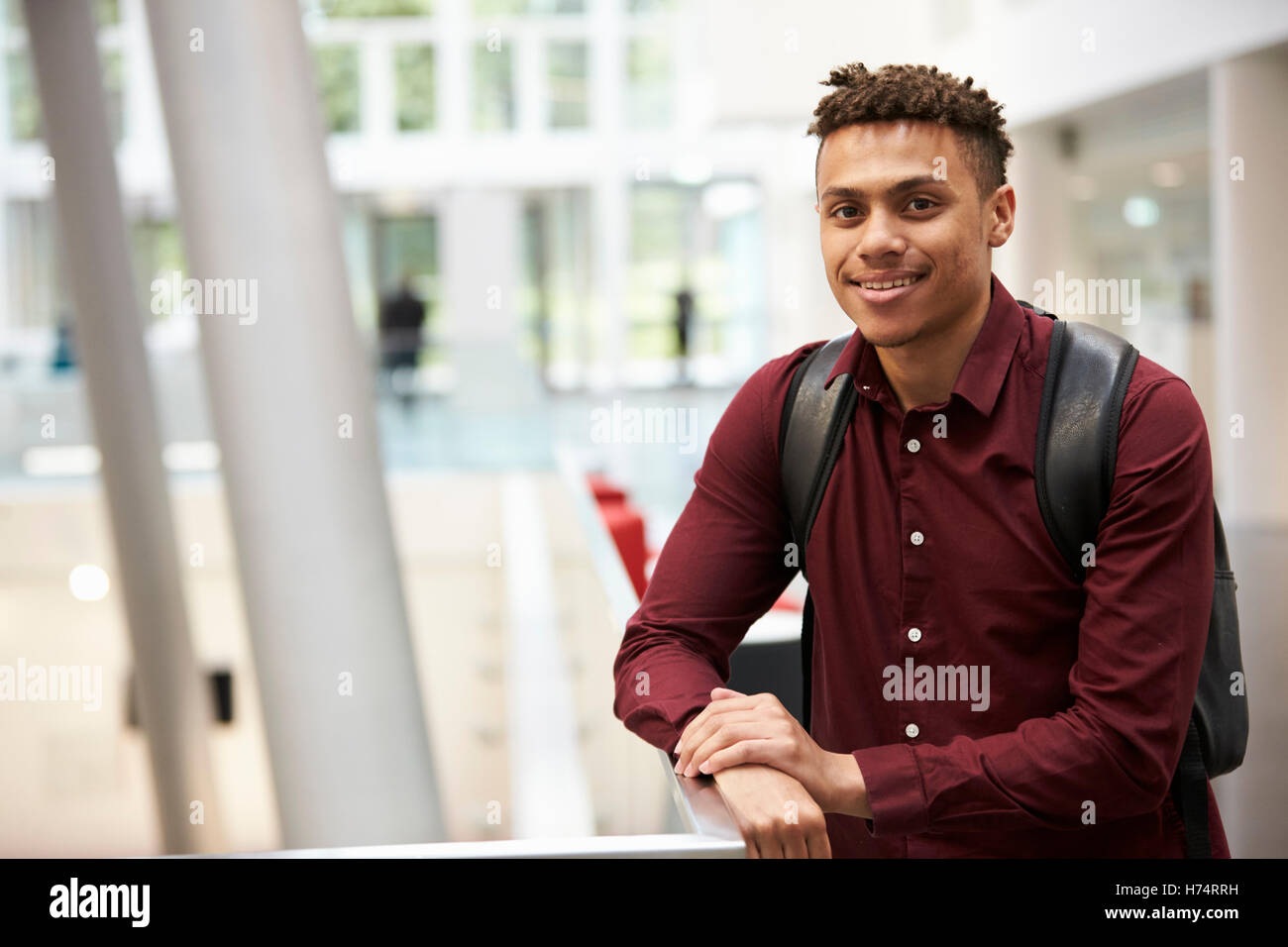 Young adult male student in modern university lobby Stock Photo - Alamy