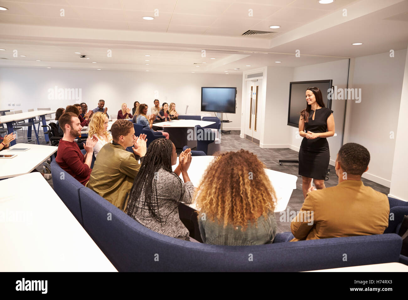 Female teacher addressing university students in a classroom Stock ...