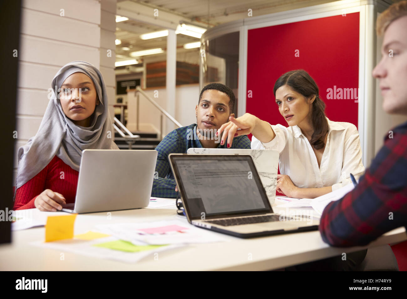 Group Of Students Meeting For Tutorial With Teacher Stock Photo - Alamy