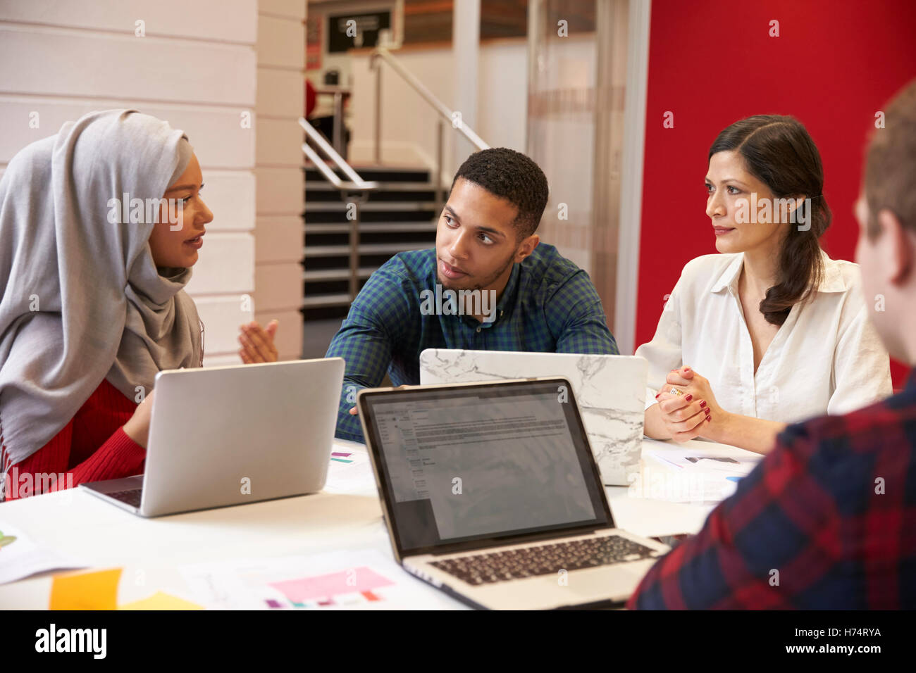Group Of Students Meeting For Tutorial With Teacher Stock Photo - Alamy