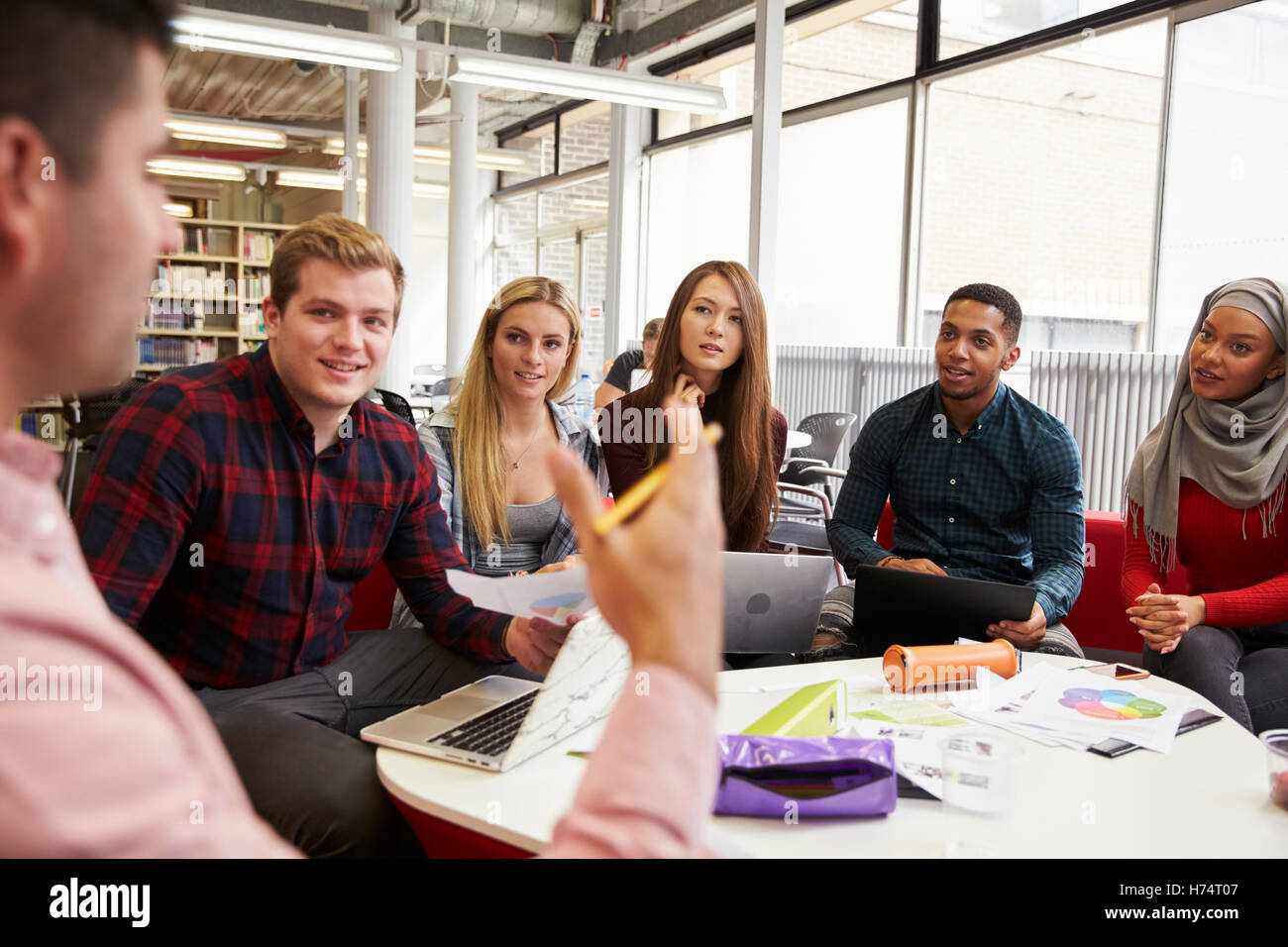 Group Of Students In Library Collaborating On Project Stock Photo - Alamy