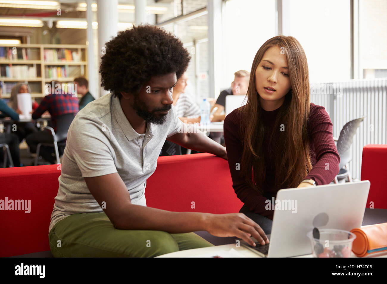 Female University Student Working In Library With Tutor Stock Photo - Alamy