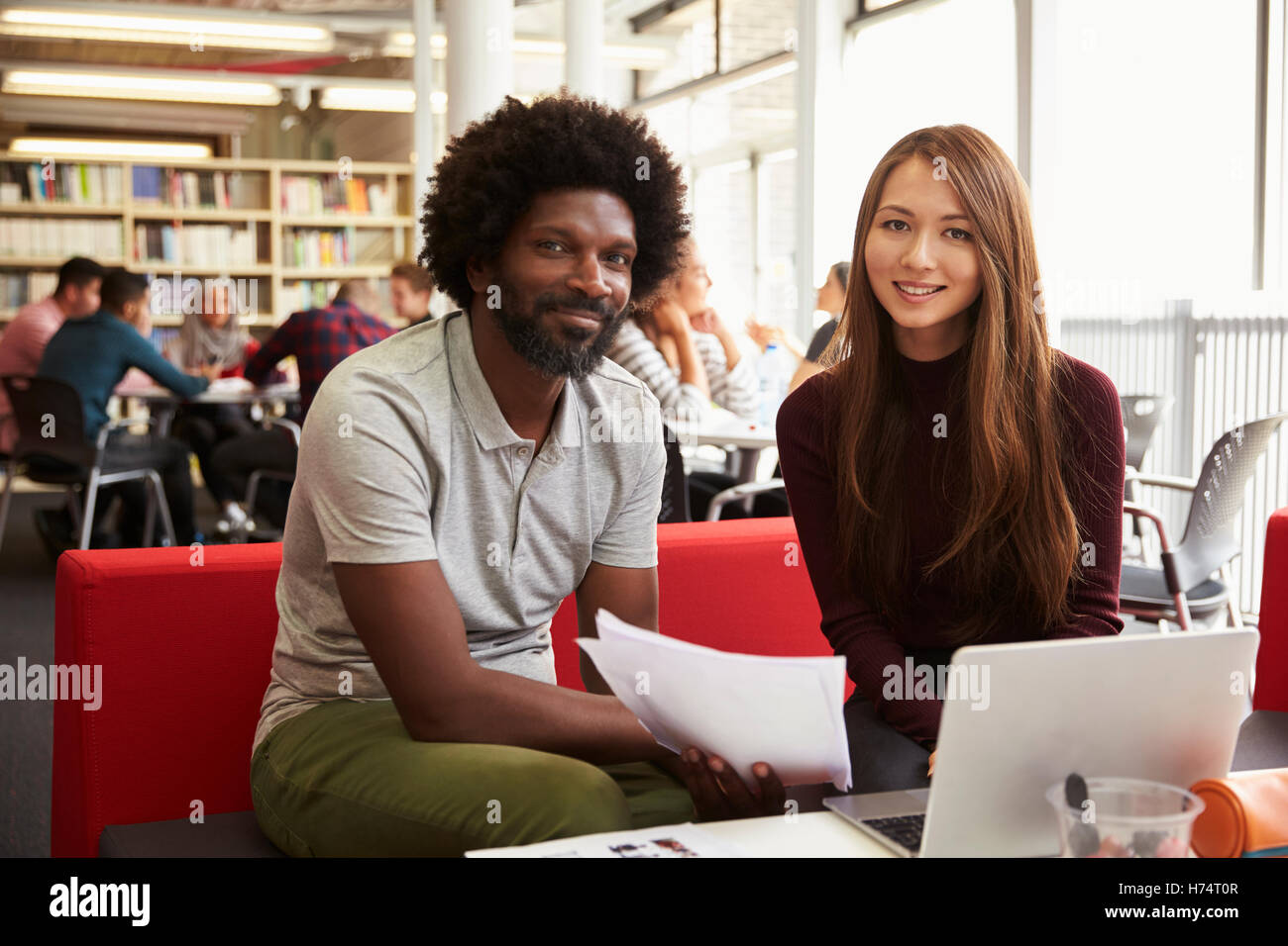 Female University Student Working In Library With Tutor Stock Photo - Alamy