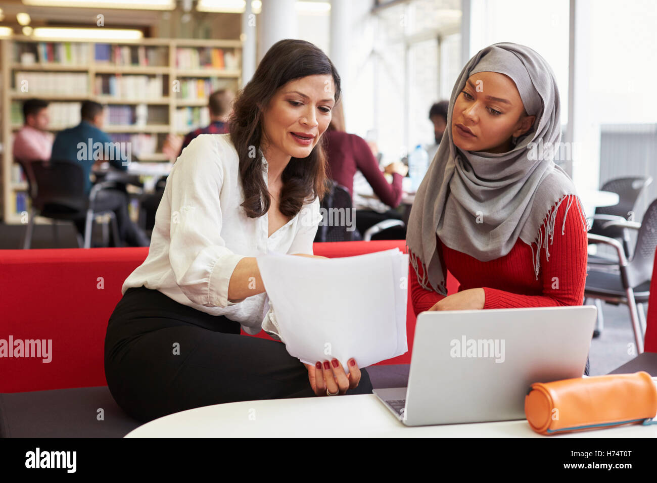 Female University Student Working In Library With Tutor Stock Photo - Alamy