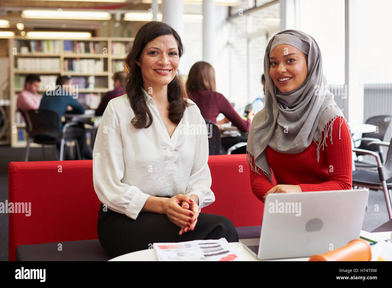 Female University Student Working In Library With Tutor Stock Photo - Alamy