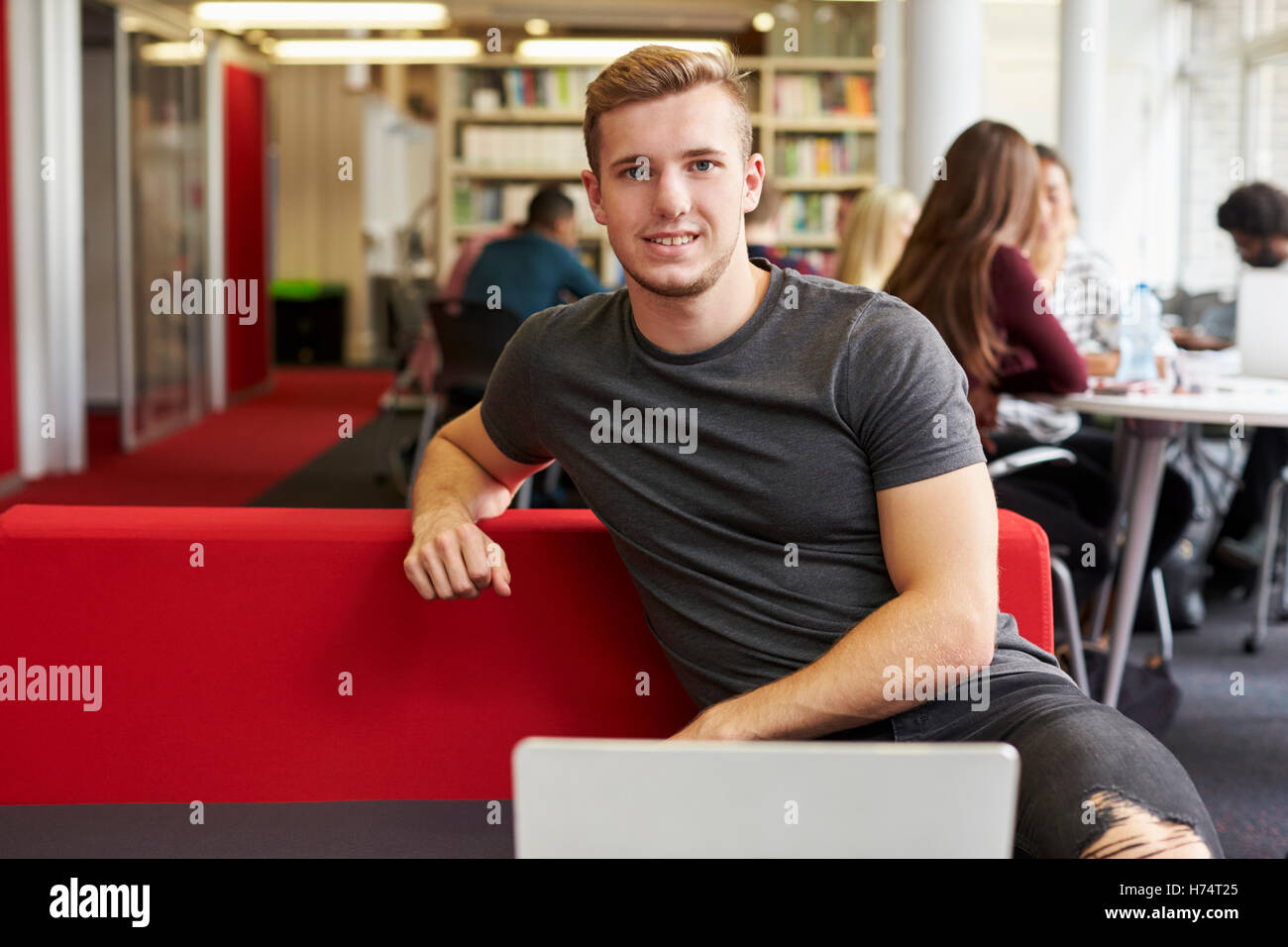 Portrait Of Male University Student Working In Library Stock Photo - Alamy