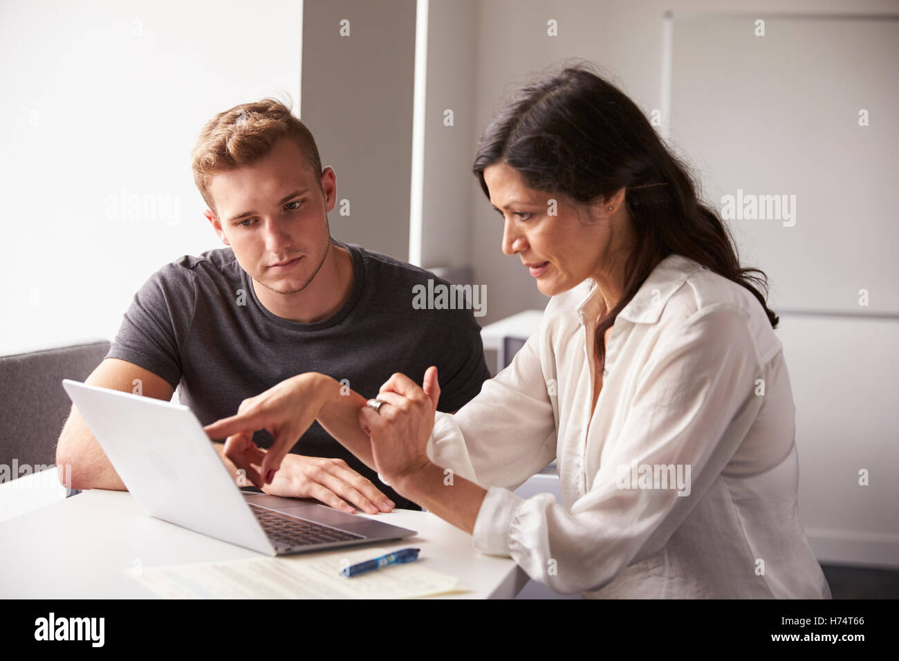 Male University Student Working One To One With Tutor Stock Photo - Alamy