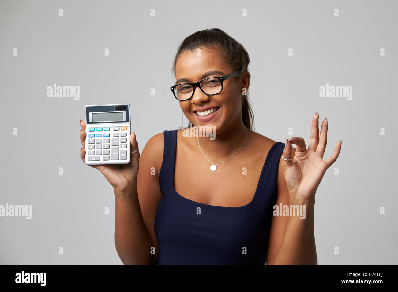 Studio Portrait Of Female Accountant Using Calculator Stock Photo - Alamy