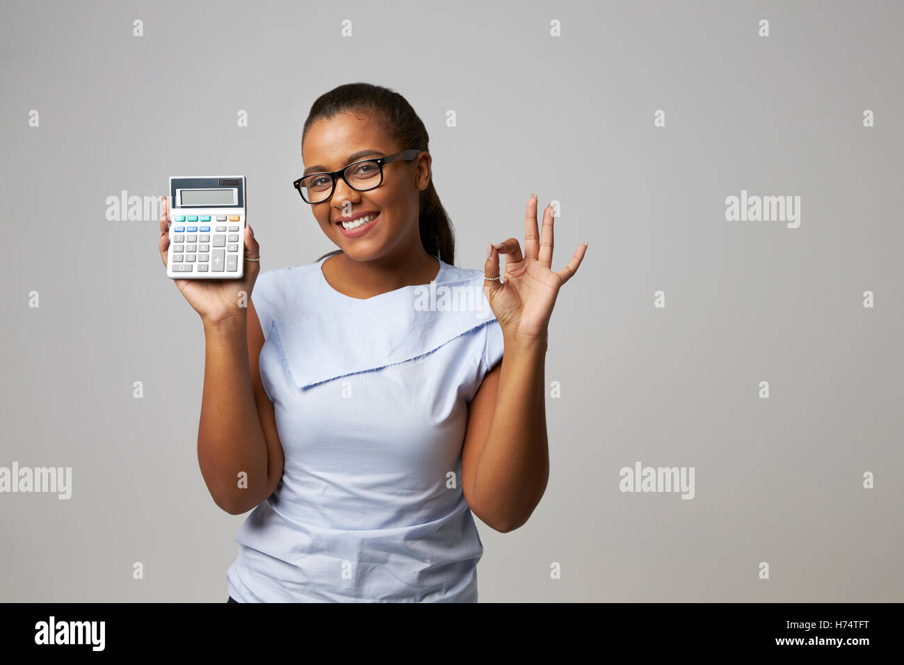 Studio Portrait Of Female Accountant Using Calculator Stock Photo - Alamy