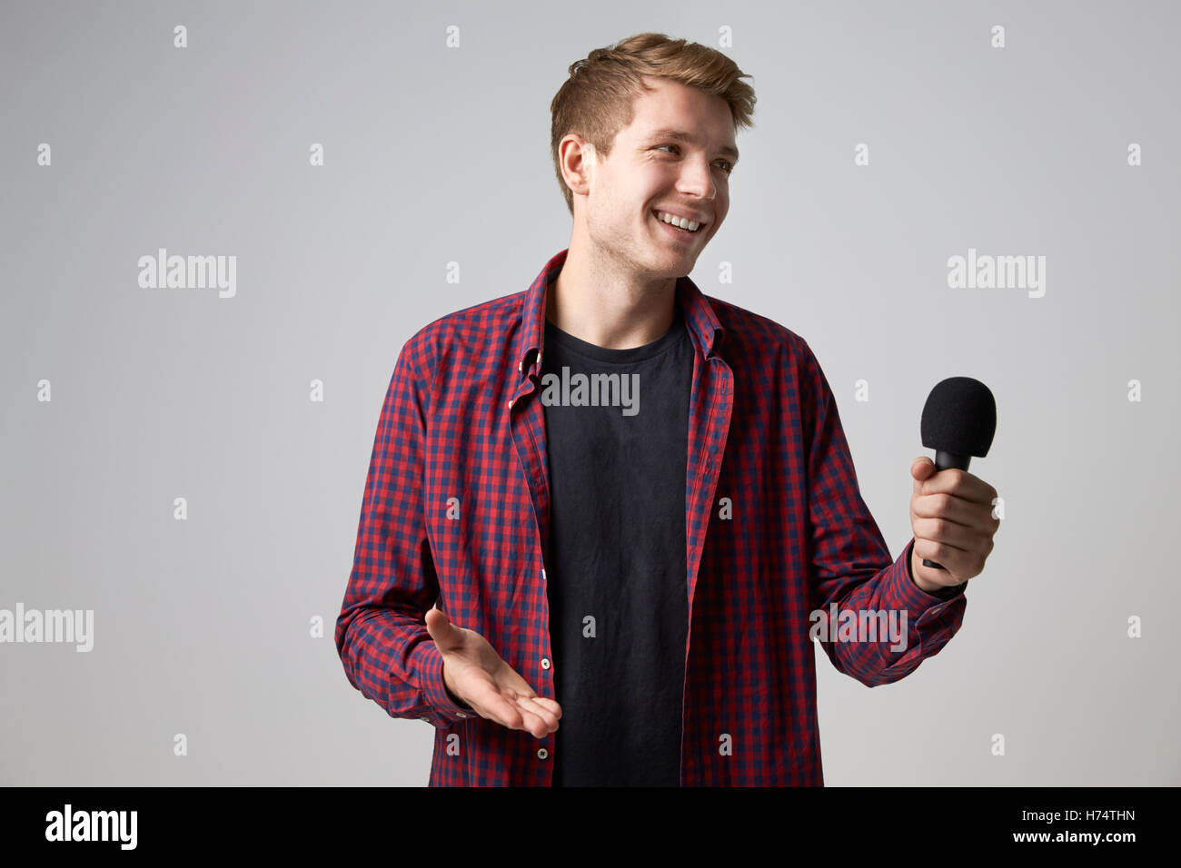 Smiling male journalist microphone hi-res stock photography and images ...