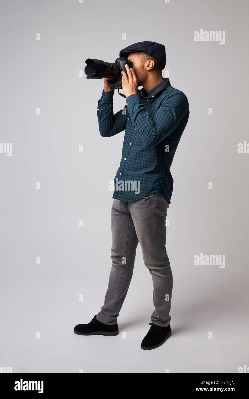 Studio Portrait Of Male Photographer With Camera Stock Photo - Alamy