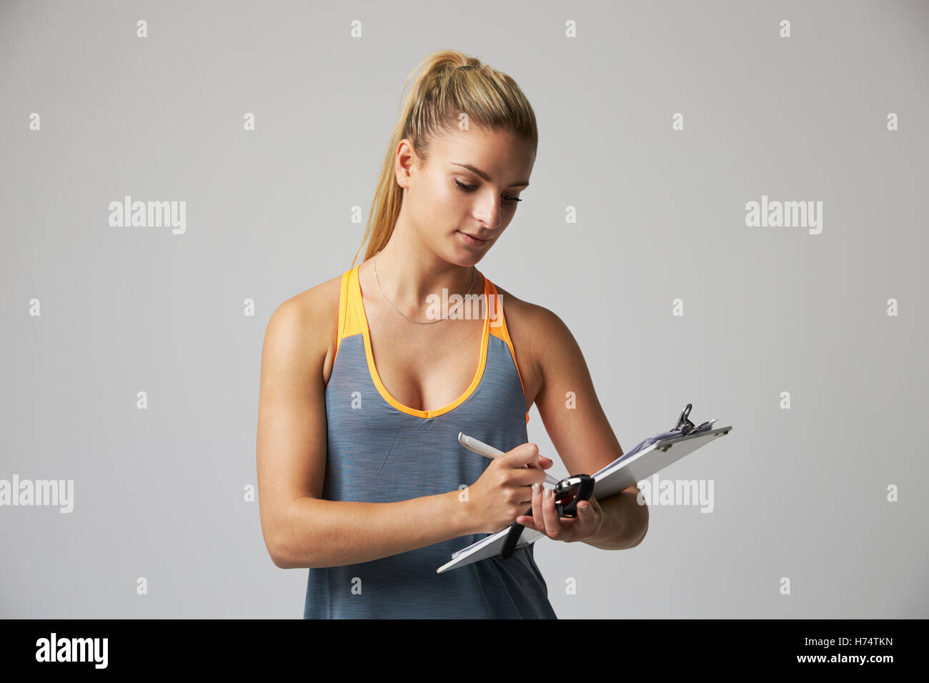 Studio Portrait Of Female Sports Coach With Clipboard Stock Photo - Alamy