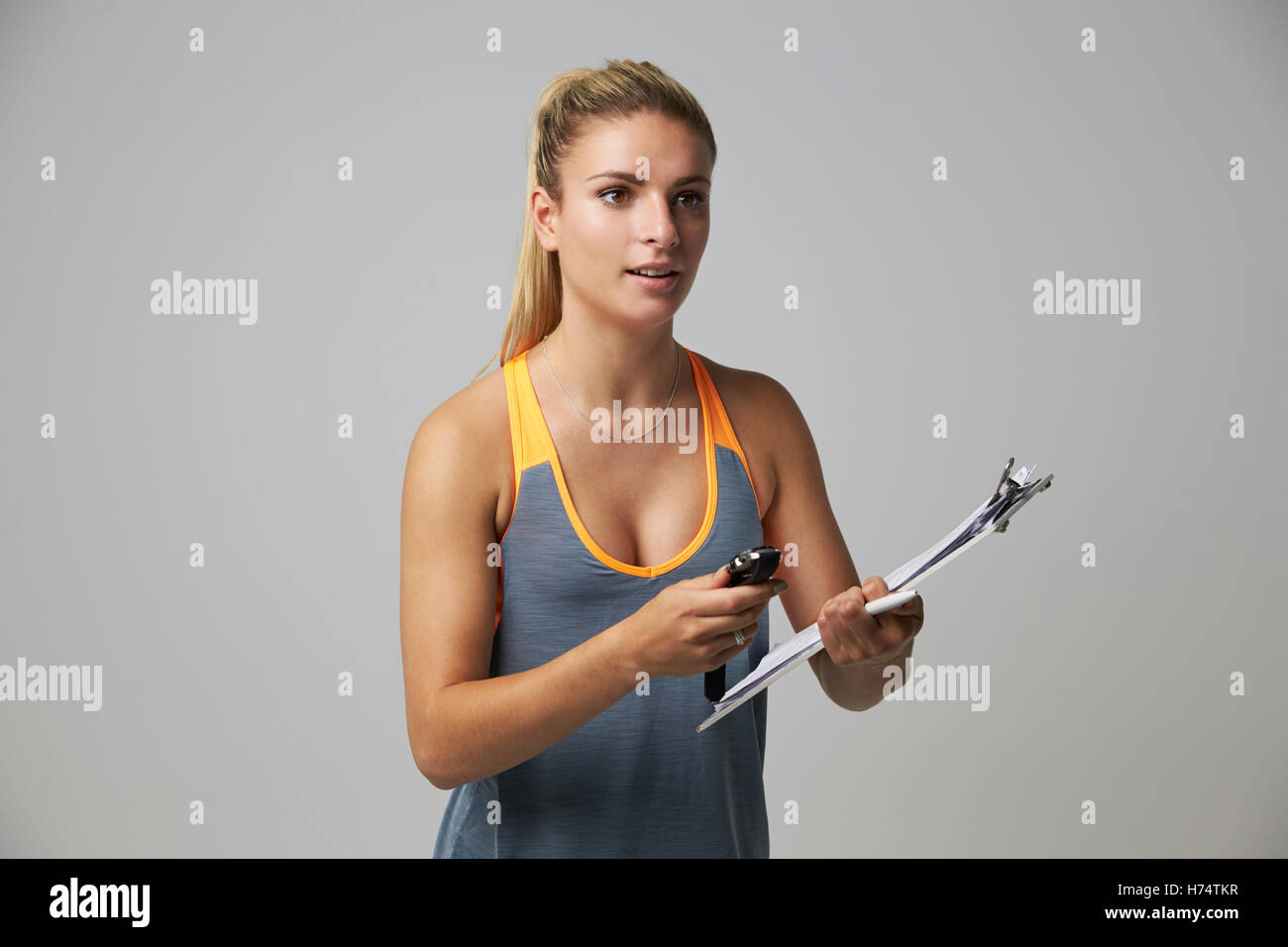 Studio Portrait Of Female Sports Coach With Clipboard Stock Photo - Alamy