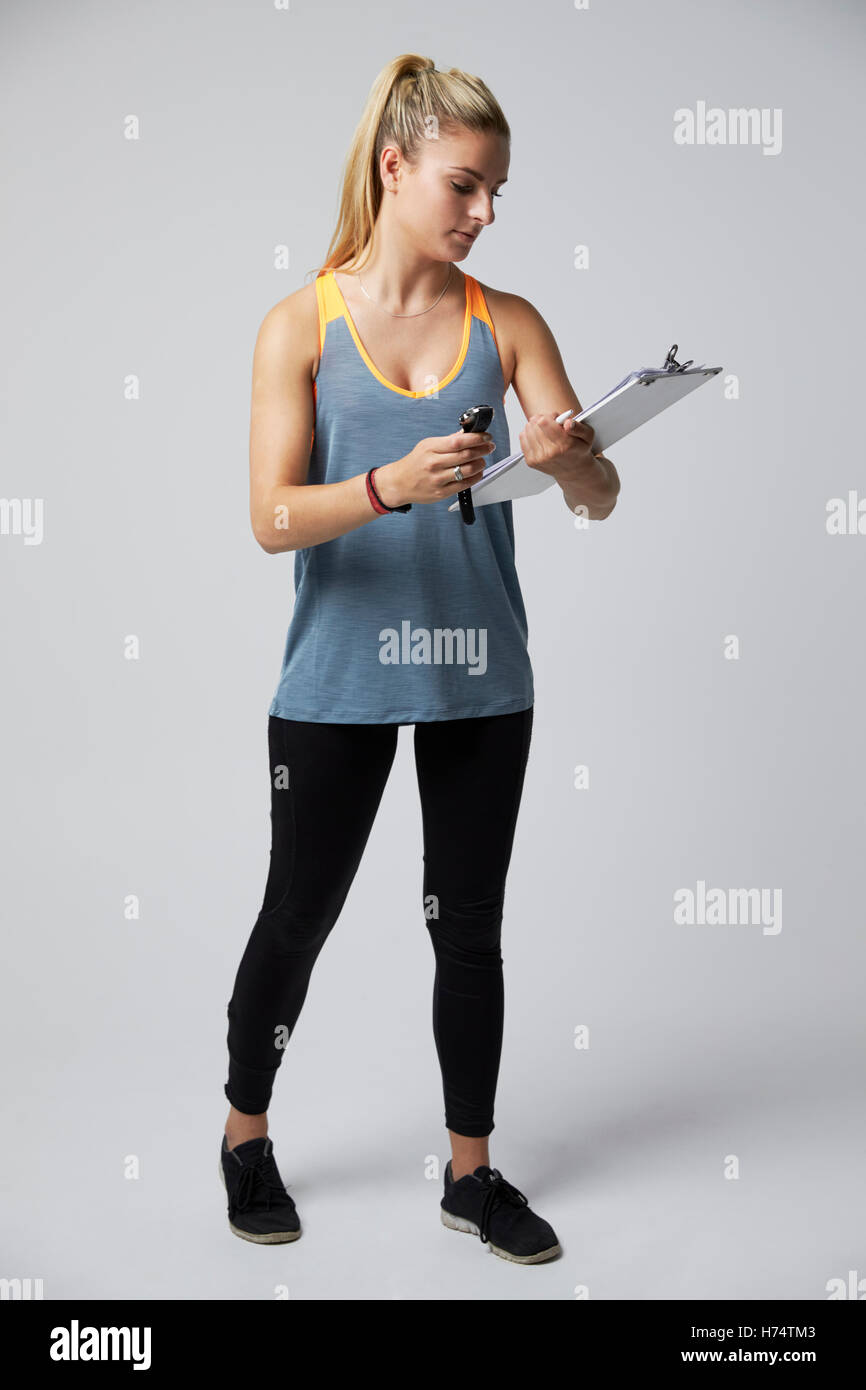 Studio Portrait Of Female Sports Coach With Clipboard Stock Photo - Alamy