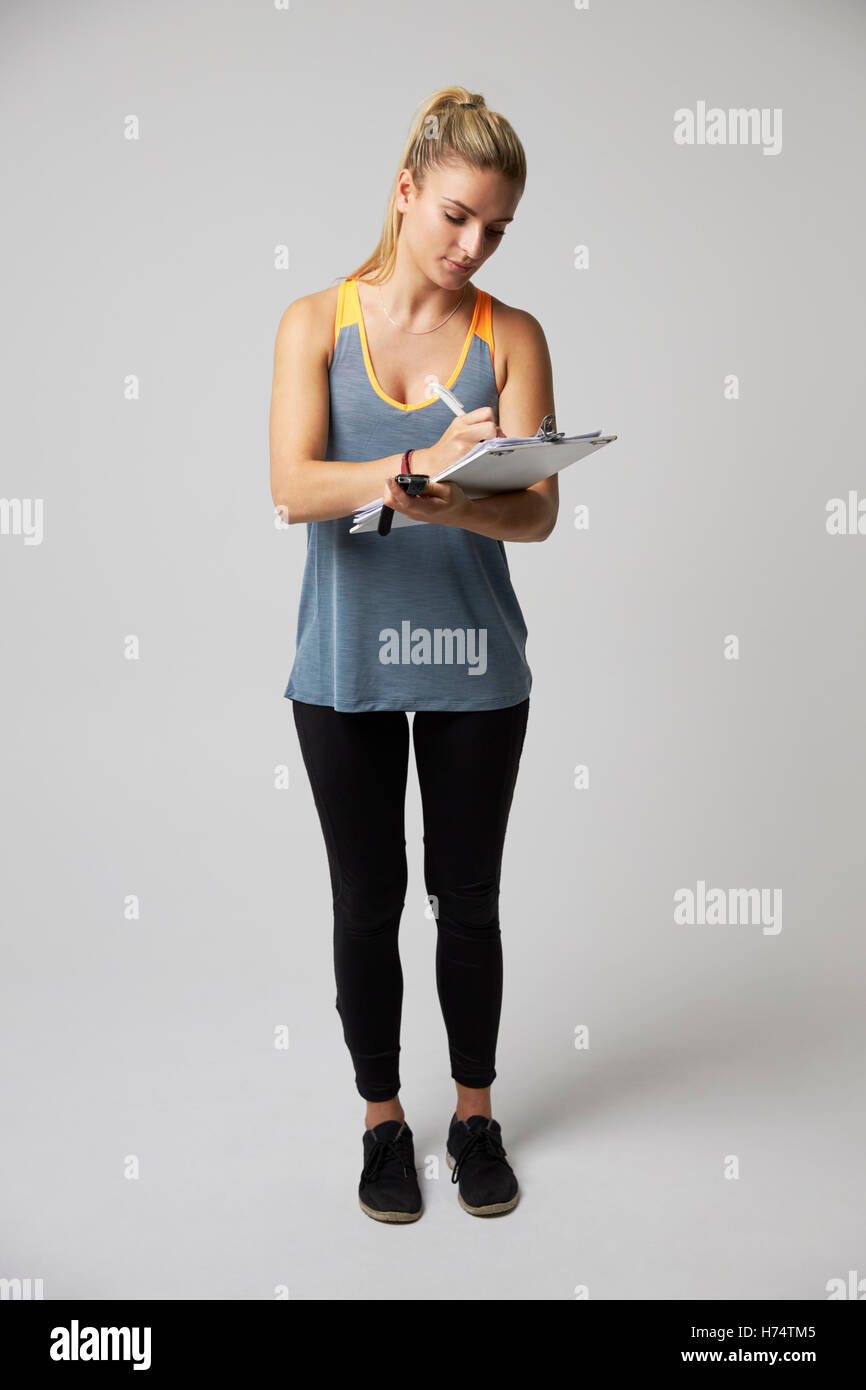Studio Portrait Of Female Sports Coach With Clipboard Stock Photo - Alamy