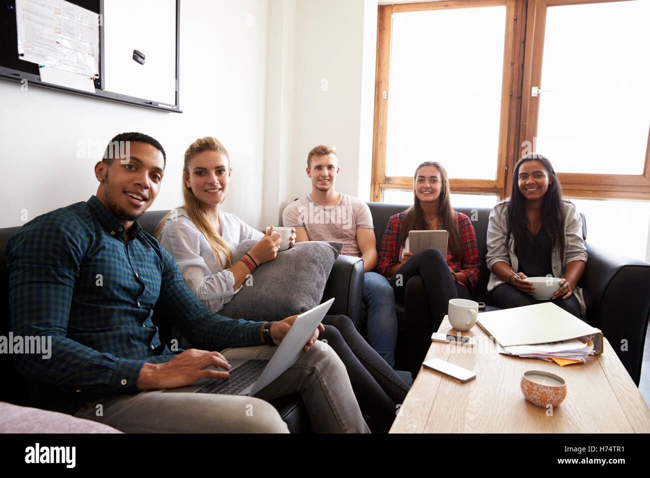 Students Relaxing In Lounge Of Shared Accommodation Stock Photo - Alamy