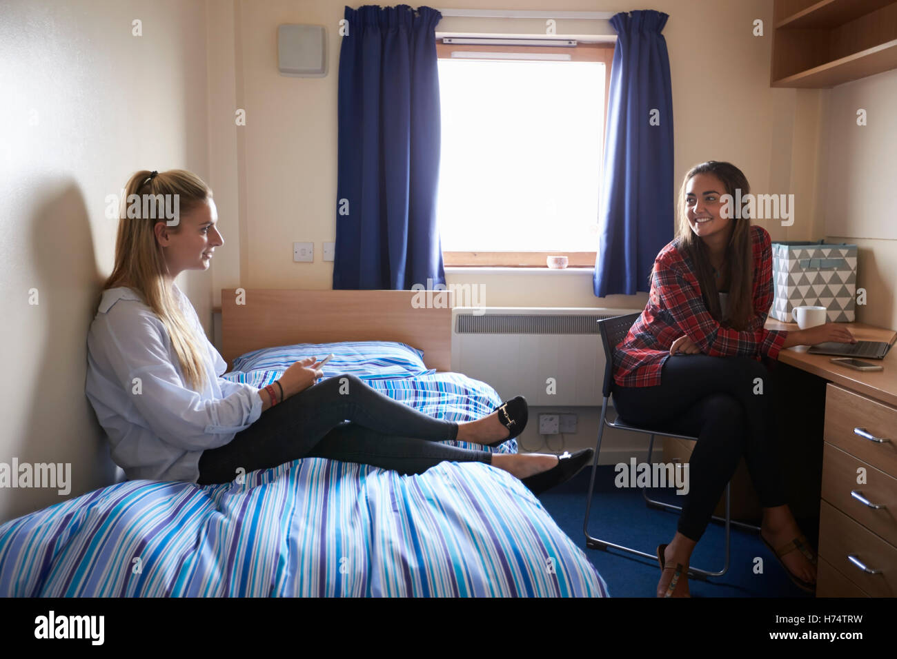 Female Students Working In Bedroom Of Campus Accommodation Stock Photo ...