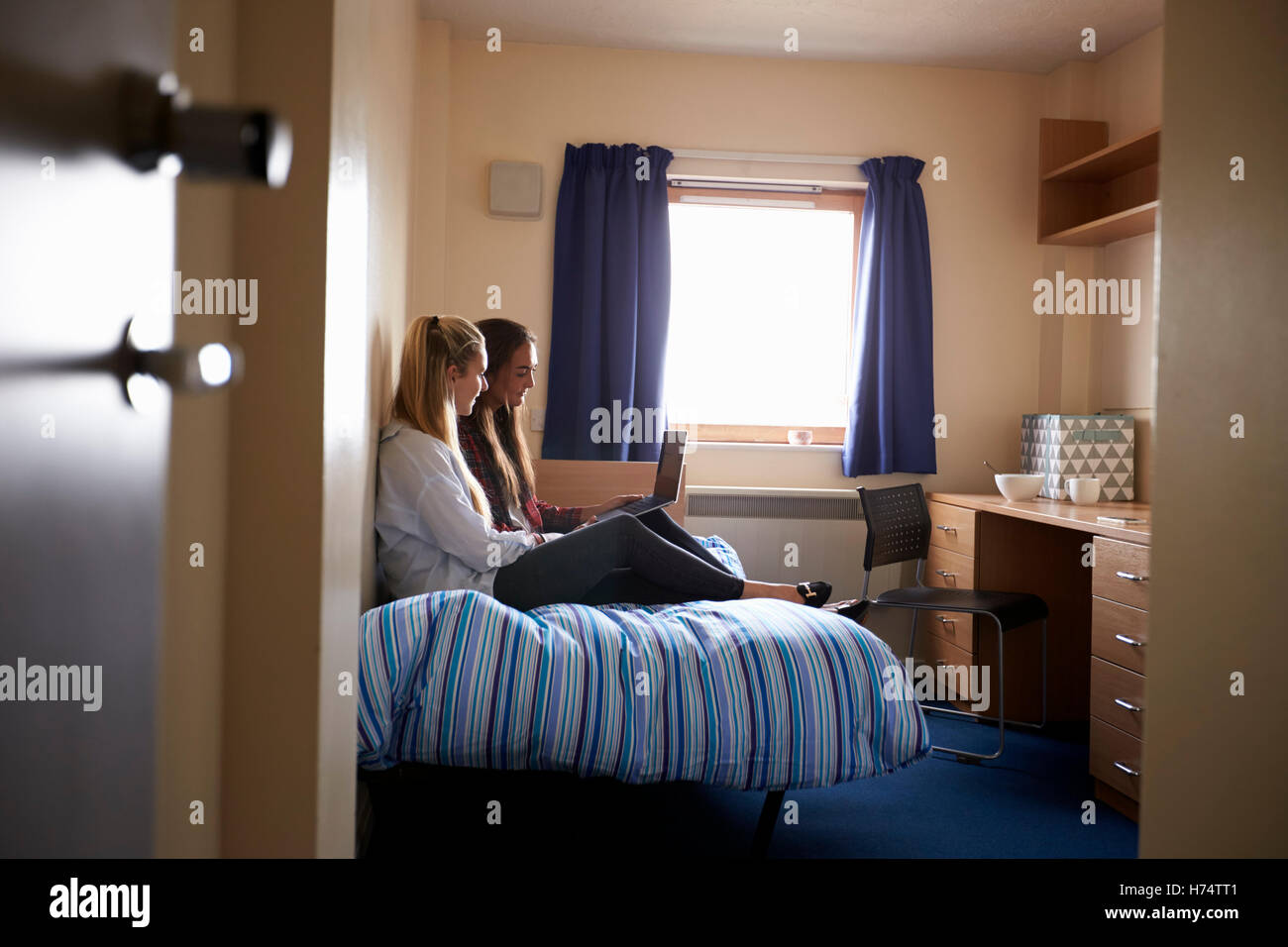Female Students Working In Bedroom Of Campus Accommodation Stock Photo ...