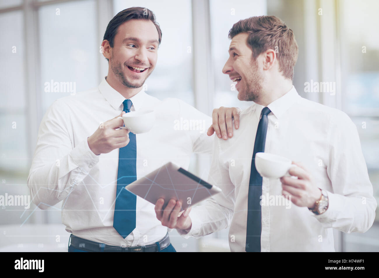 Two businessmen drinking coffee in an office Stock Photo - Alamy