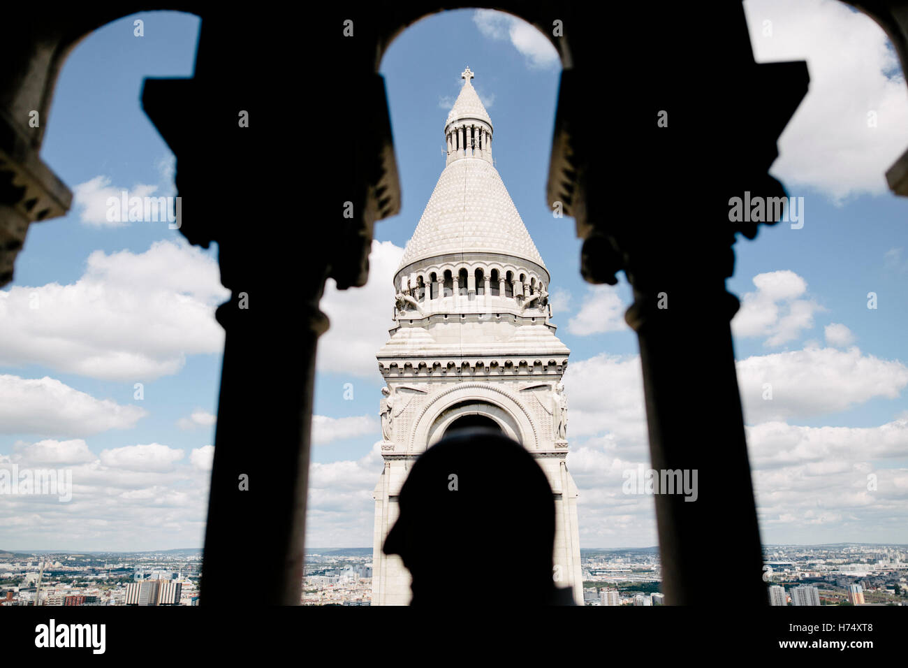 The bell tower of the Sacre-Coeur in Paris is seen behind the outline ...