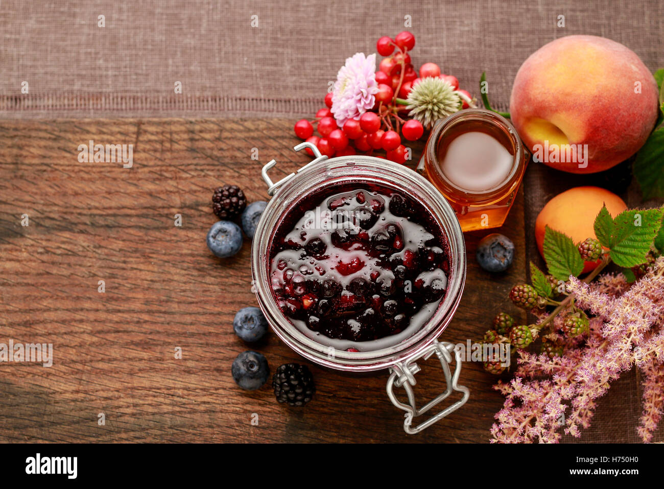 Jar of jam and autumn fruits on wooden background, copy space Stock ...