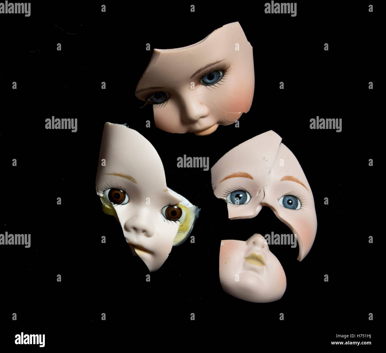 Doll Heads Broken on Black Background Stock Photo - Alamy
