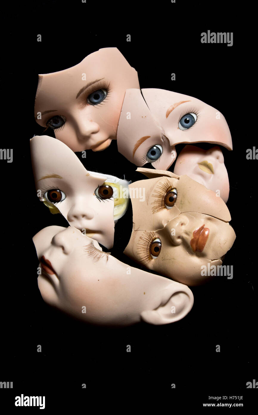 Doll Heads Broken on Black Background Stock Photo - Alamy