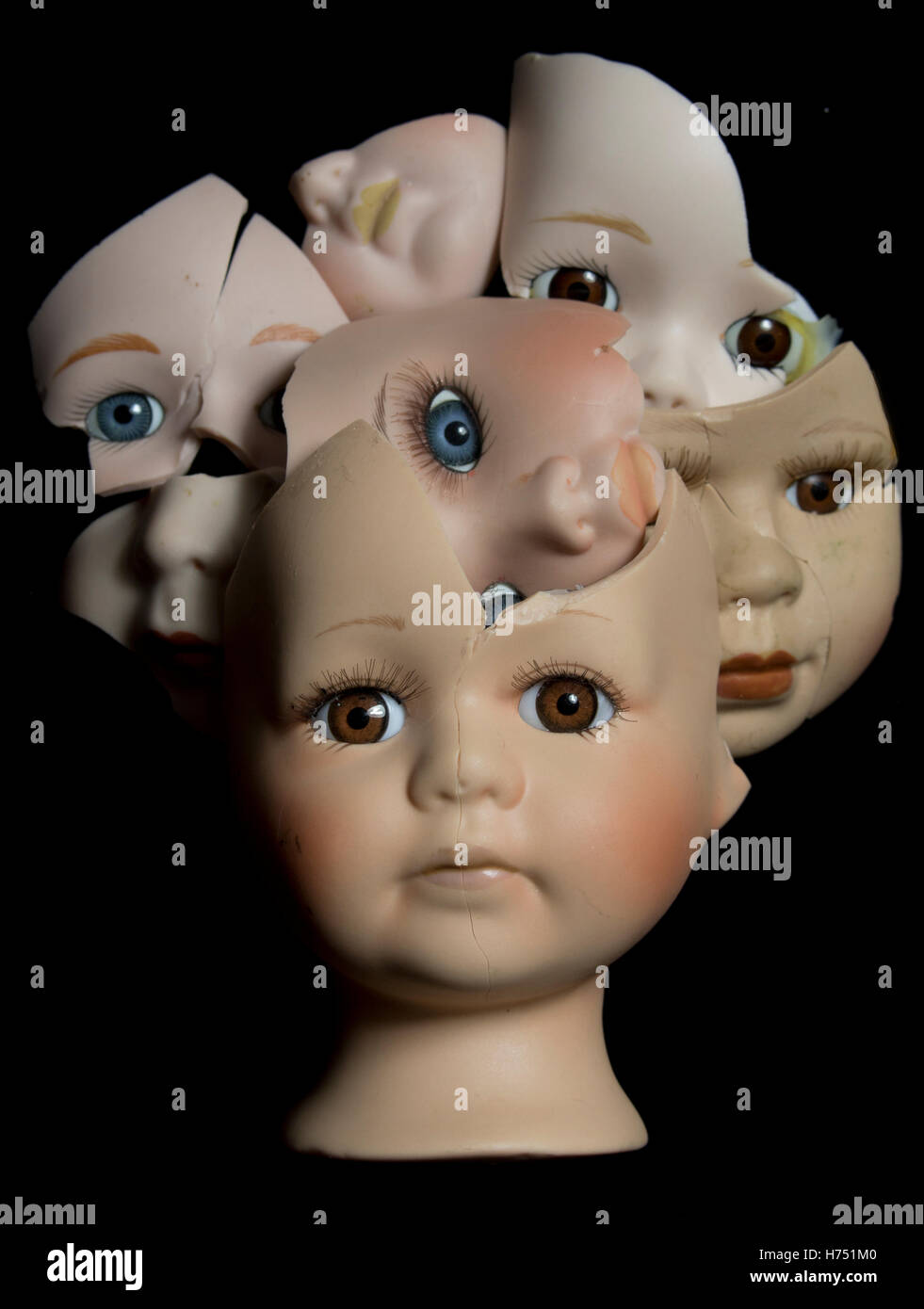 Doll Heads Broken on Black Background Stock Photo - Alamy