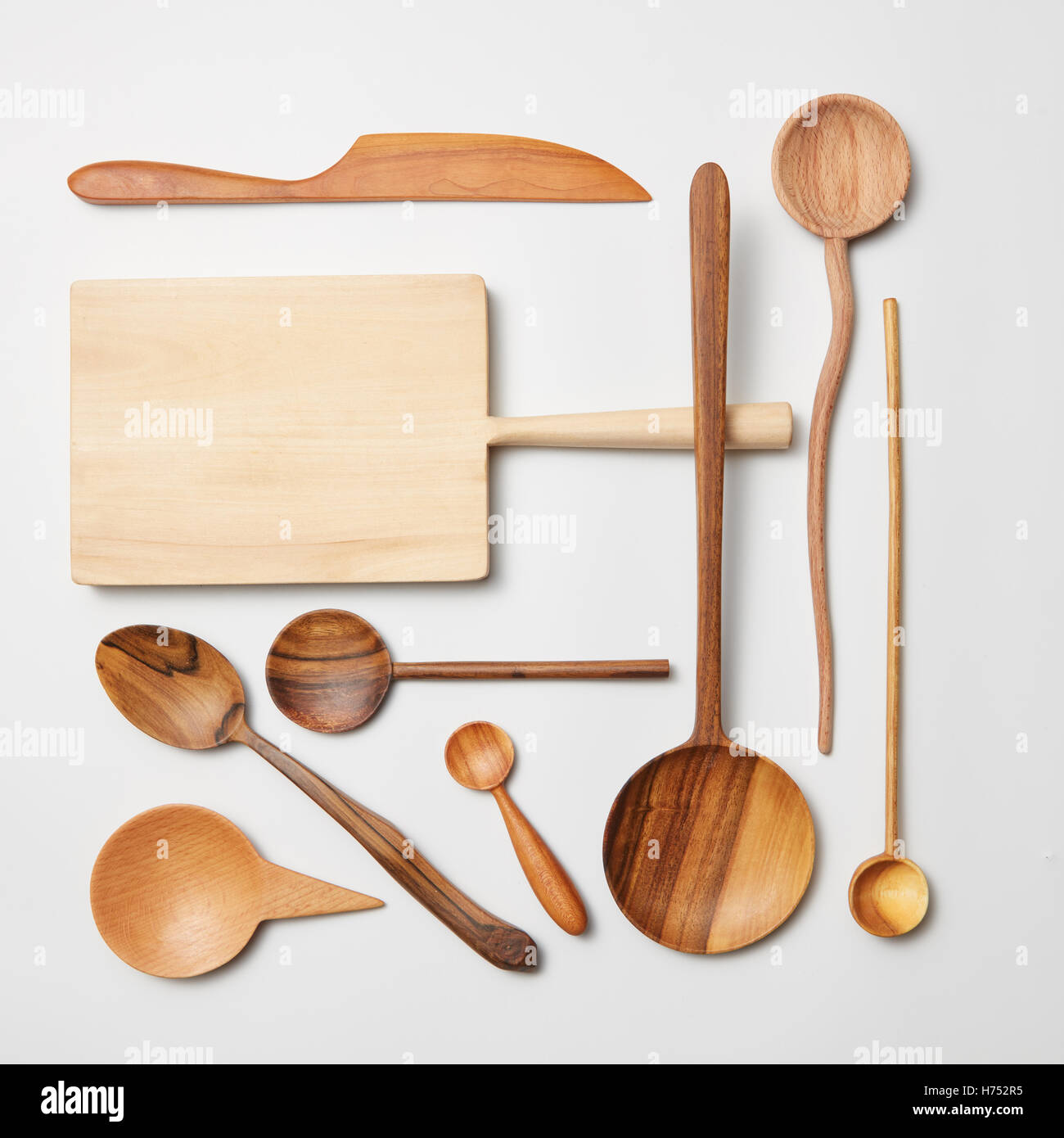 Wooden kitchen utensils on white background. Cutting board, fork, knife ...