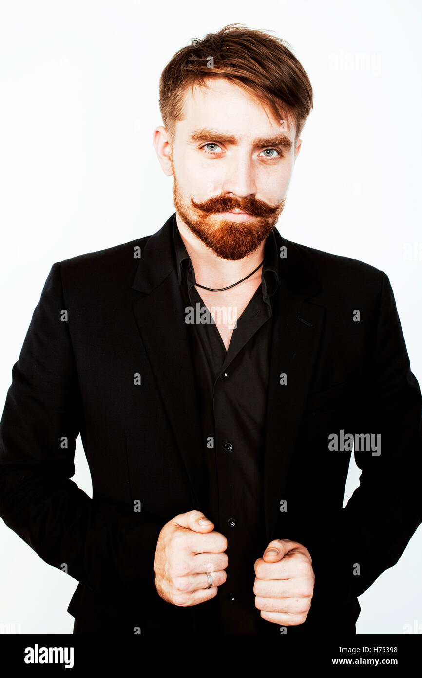 young red hair man with beard and mustache in black suit on whit Stock ...