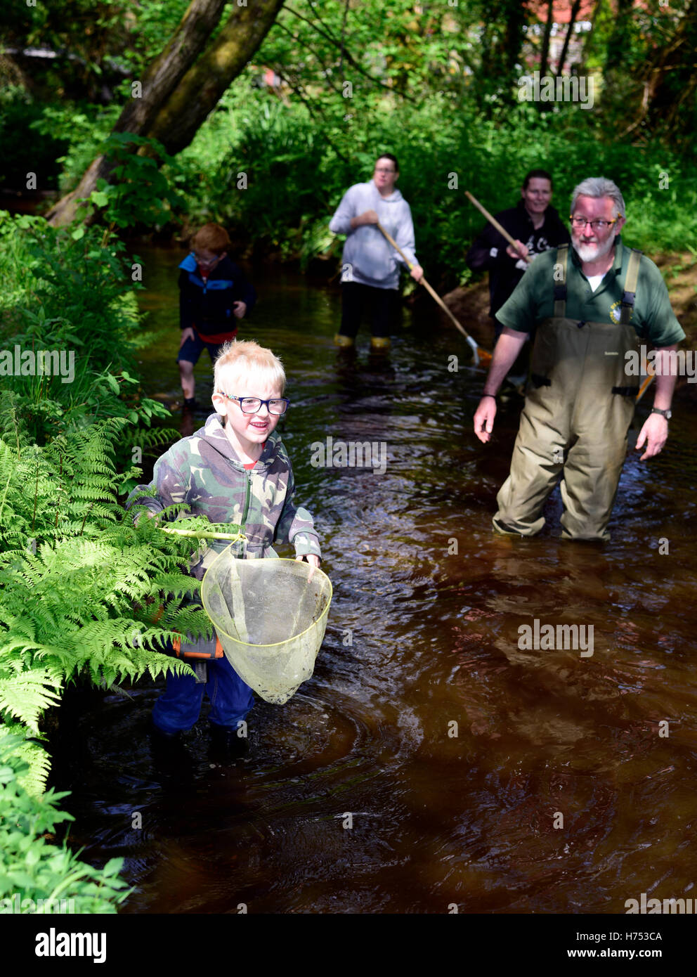 Locals enjoying searching for signs of river life at an environment ...