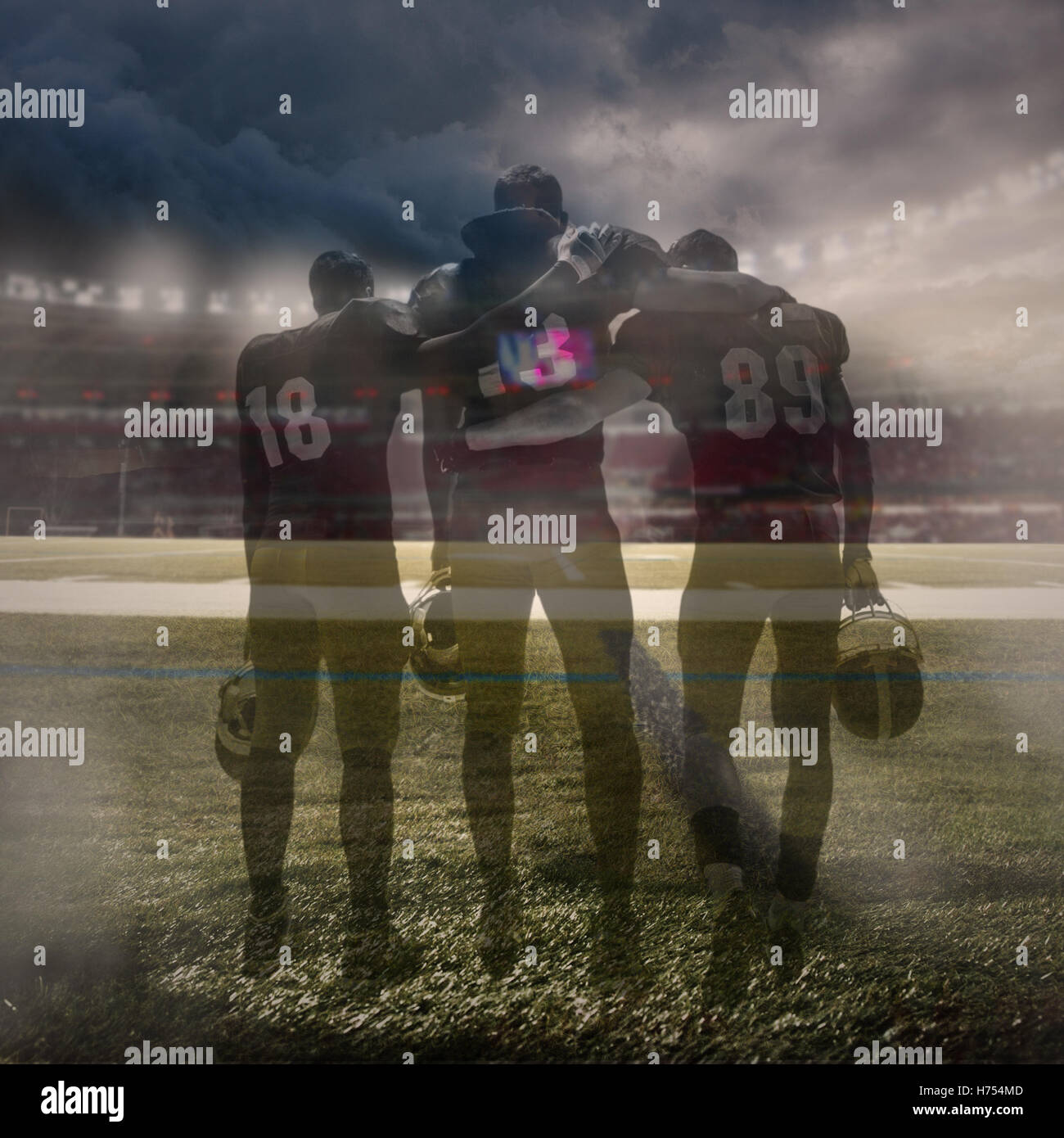 The three american football players in action Stock Photo - Alamy