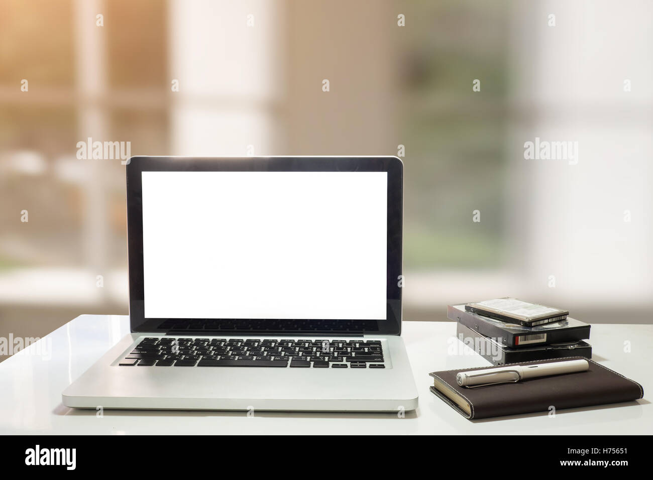 Place of work with notebook or laptop and mouse on wood desk against ...