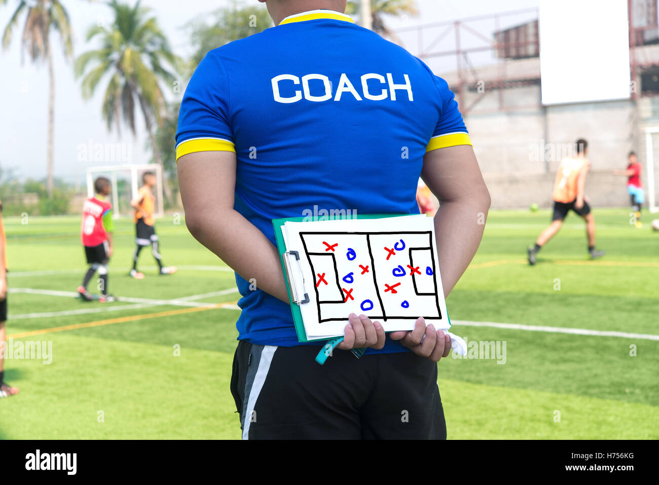 Coach is coaching Children Training In Soccer Team Stock Photo - Alamy