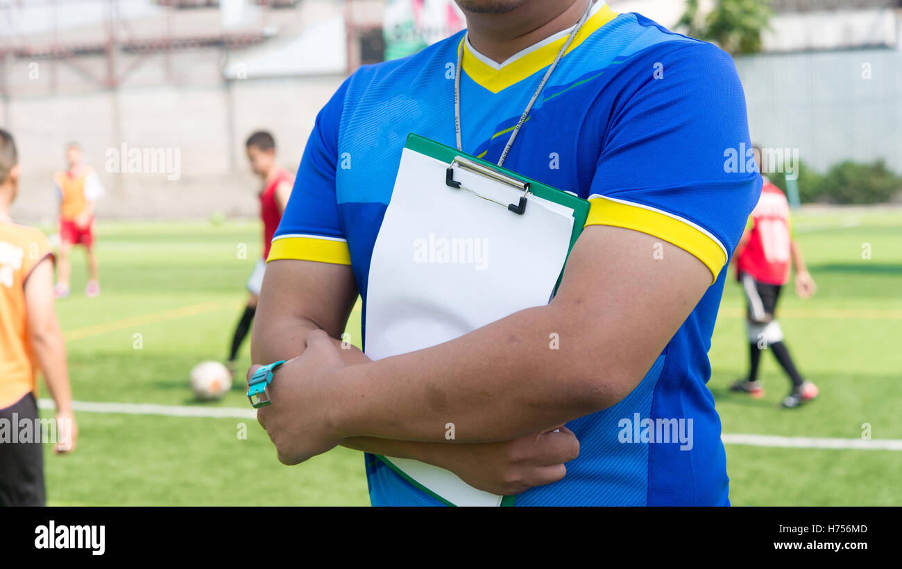 Coach is coaching Children Training In Soccer Team Stock Photo - Alamy