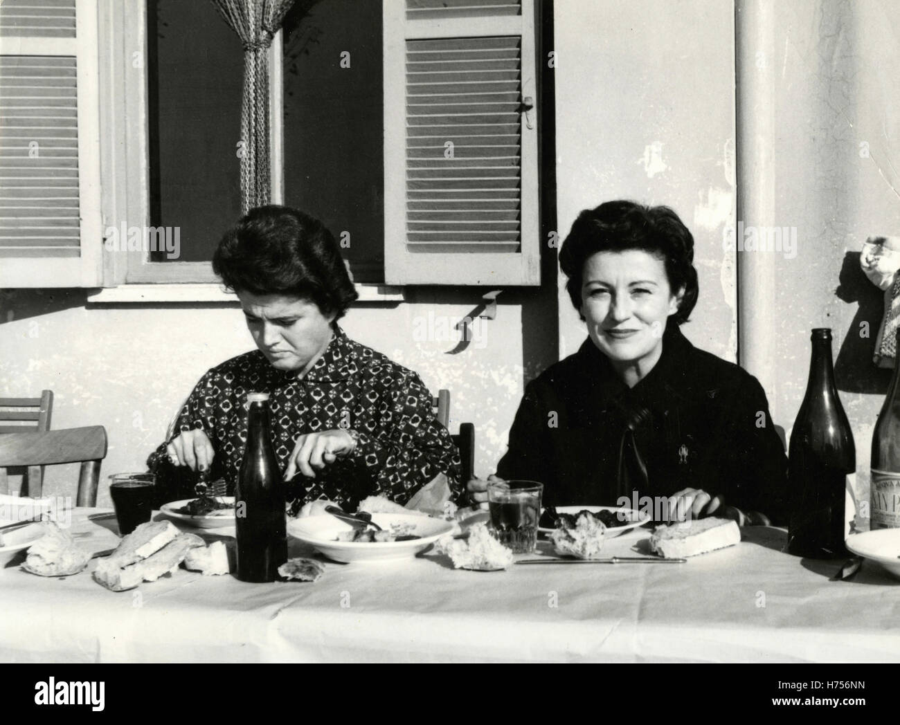 Two women at the table, Italy Stock Photo - Alamy