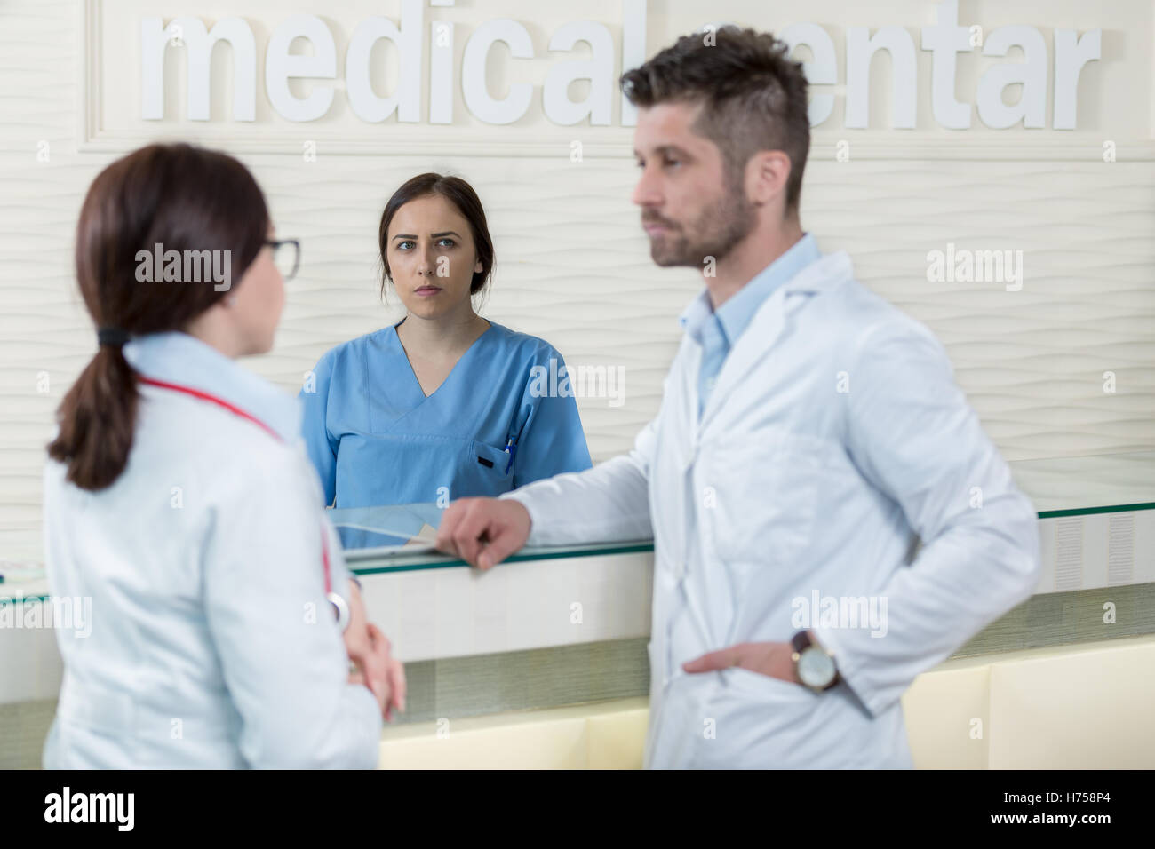 Medical Staff Having Discussion In Modern Hospital Corridor Stock Photo ...