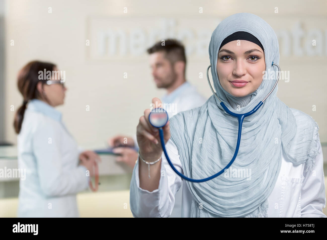 Front view of an arab doctor woman showing stethoscope Stock Photo - Alamy