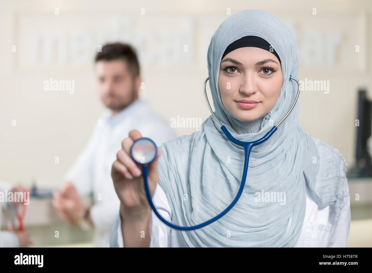 Front view of an arab doctor woman showing stethoscope Stock Photo - Alamy