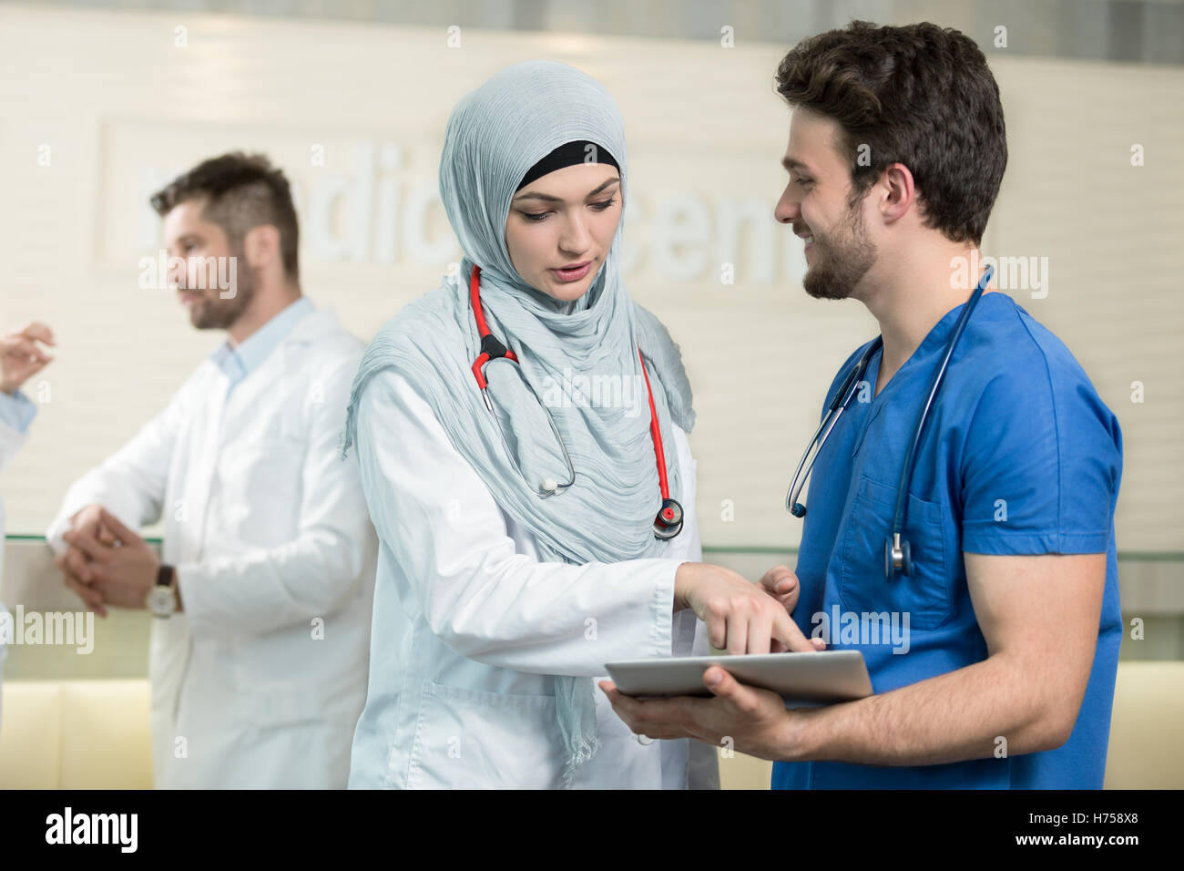 Saudi arab doctors working with a tablet Stock Photo - Alamy