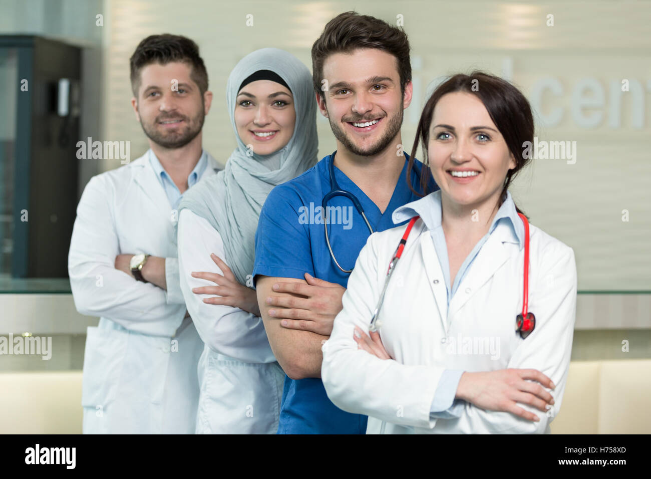 attractive male doctor in front of medical group Stock Photo - Alamy