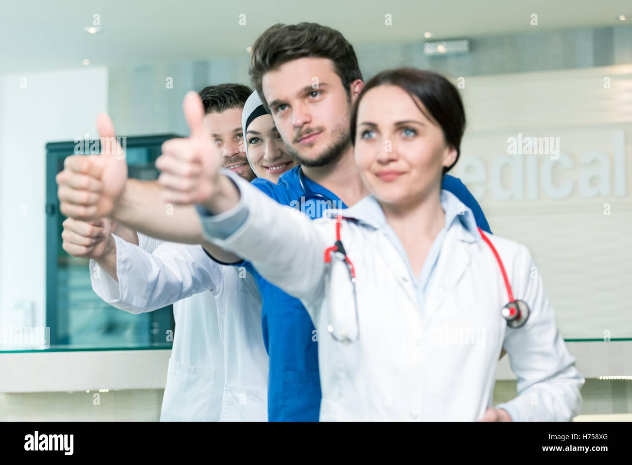 attractive male doctor in front of medical group Stock Photo - Alamy