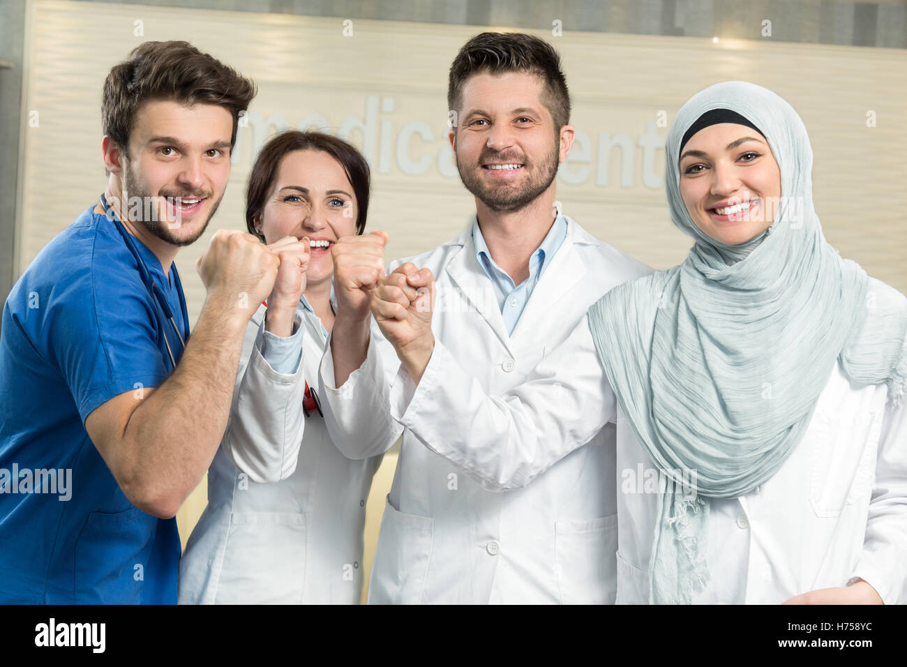 attractive male doctor in front of medical group Stock Photo - Alamy