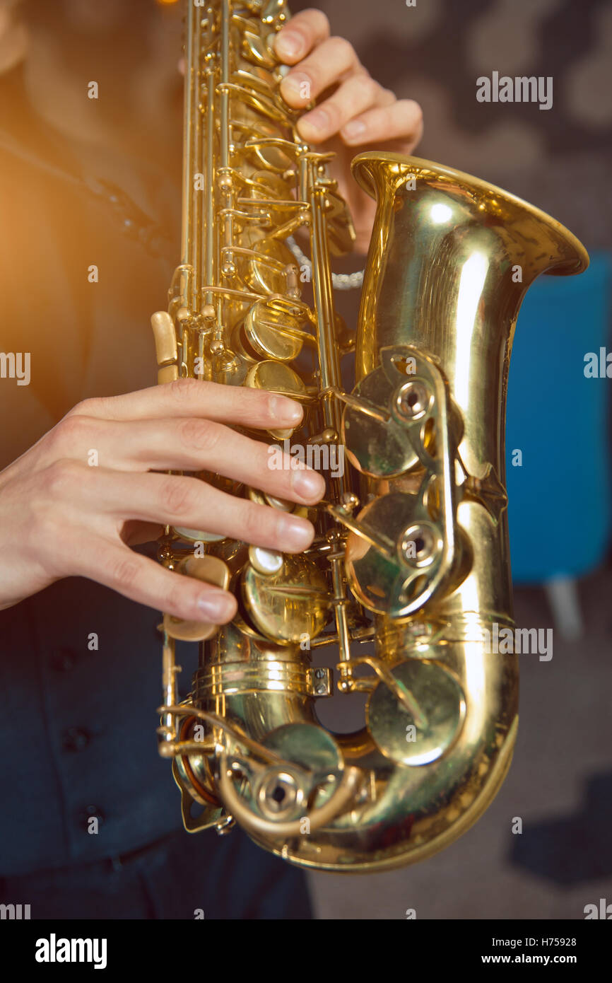 Young man in a suit hold saxophone Stock Photo - Alamy